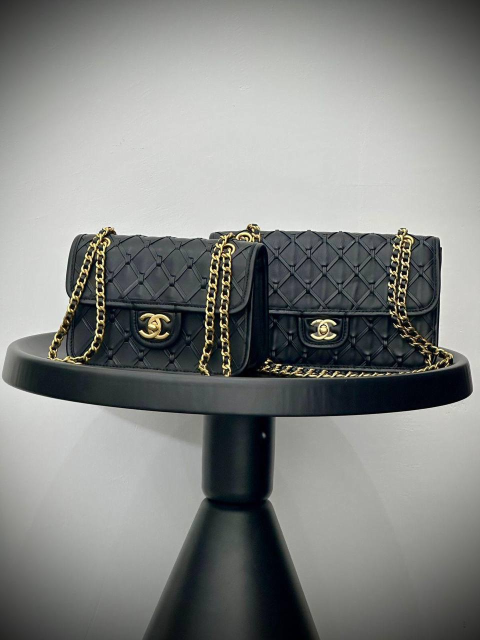 This image shows two black Chanel Classic Flap Bags side-by-side ...